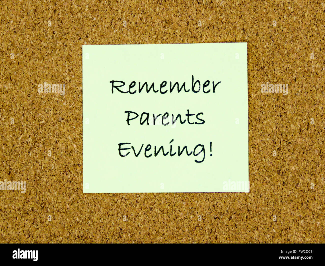 A yellow sticky note with remember parents evening written on it on a ...