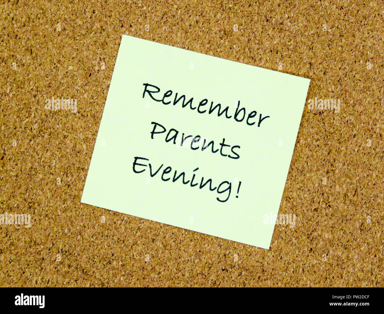 A yellow sticky note with remember parents evening written on it on a ...