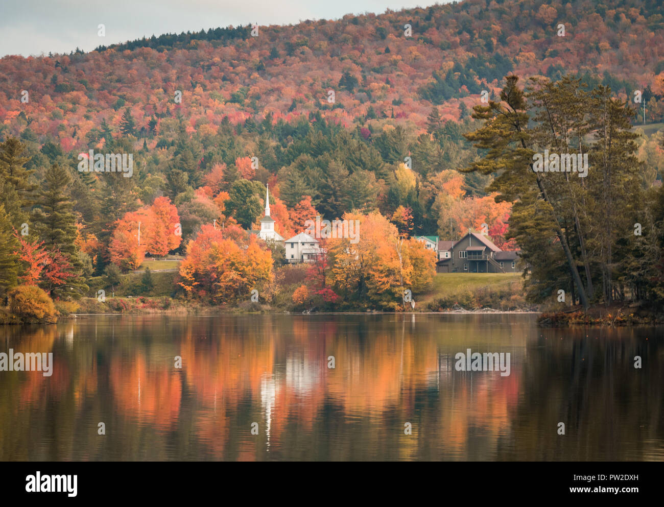 A white church steeple stands out among brilliant fall foliage in Long ...