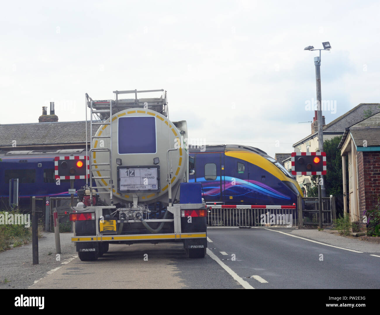 tanker lorry waiting at level crossing at howden railway station for ...