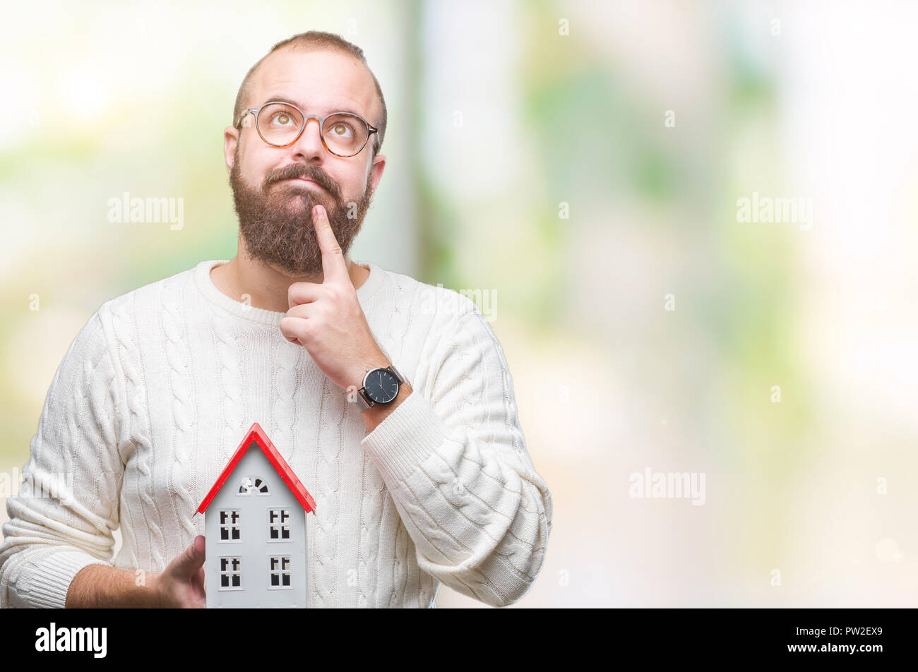 Young caucasian real state agent man holding house isolated background ...