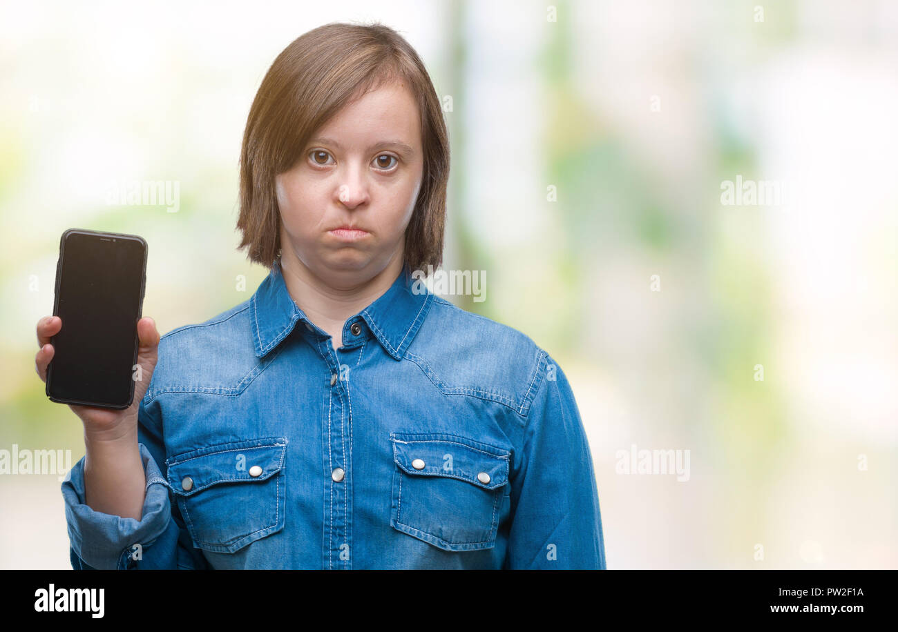 Young adult woman with down syndrome showing smartphone screen over ...