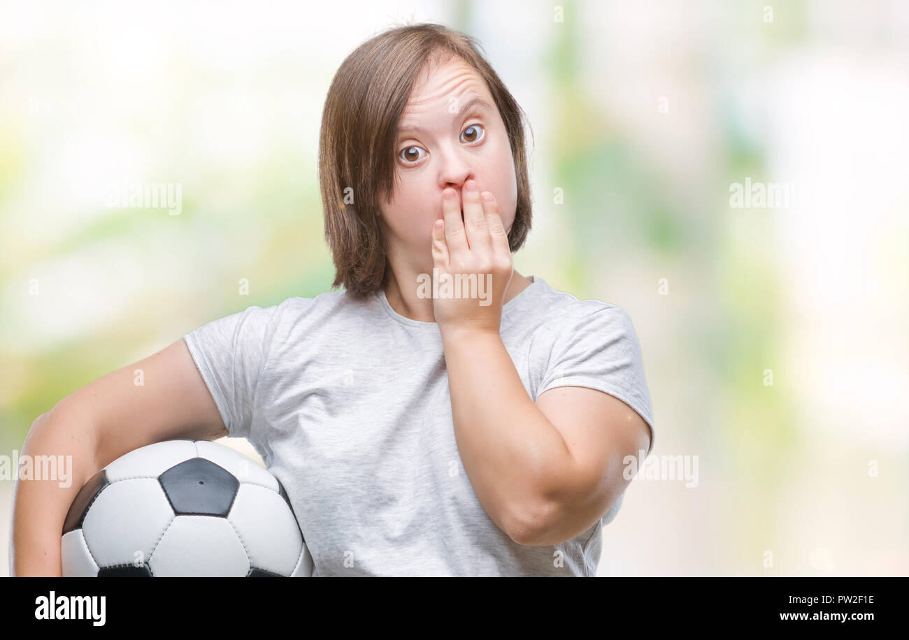 Young adult woman with down syndrome holding soccer football ball over ...
