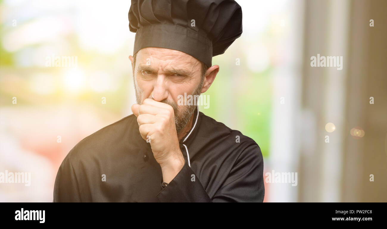 Senior cook man, wearing chef hat sick and coughing, suffering asthma ...