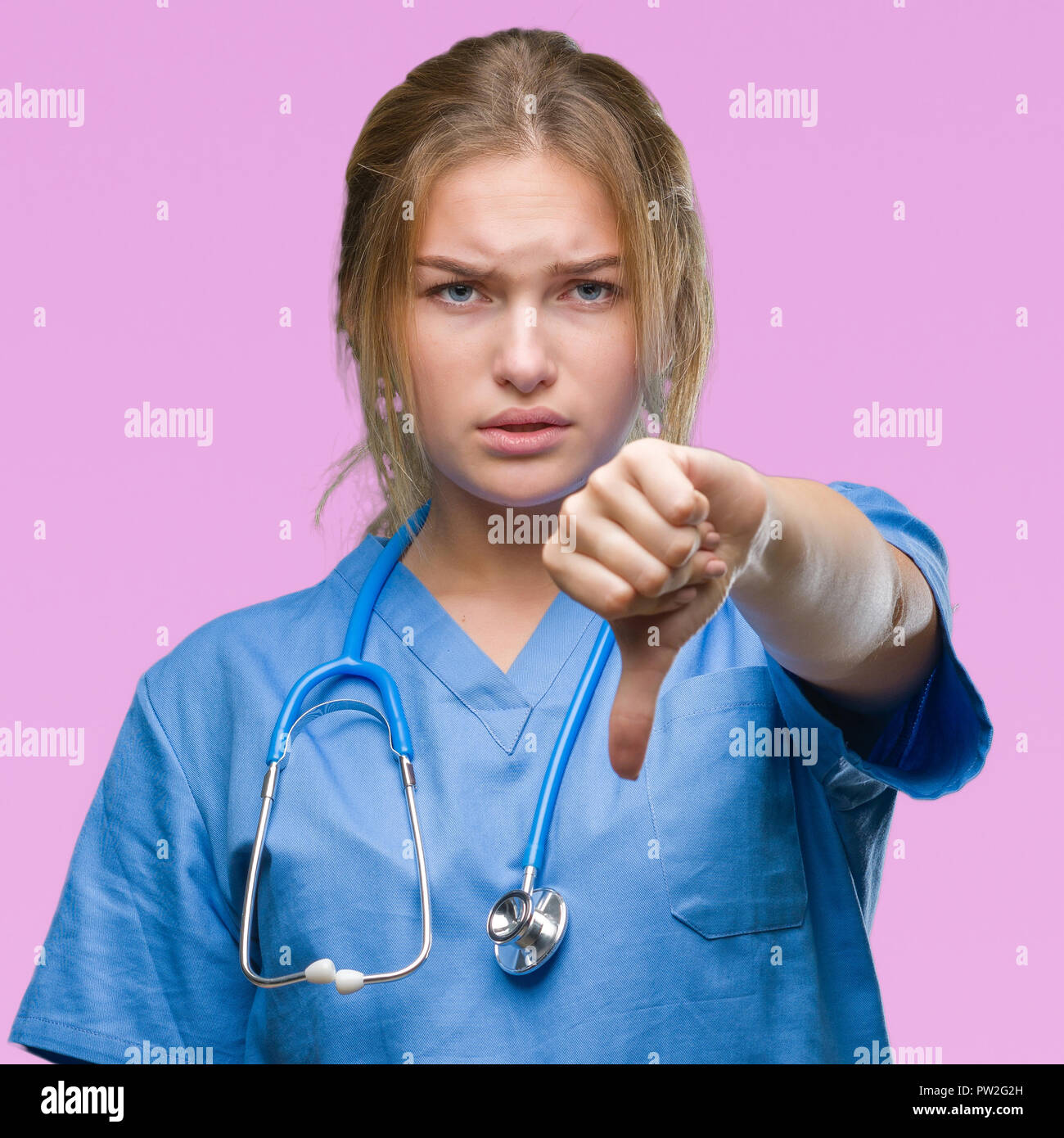Young caucasian doctor woman wearing surgeon uniform over isolated ...