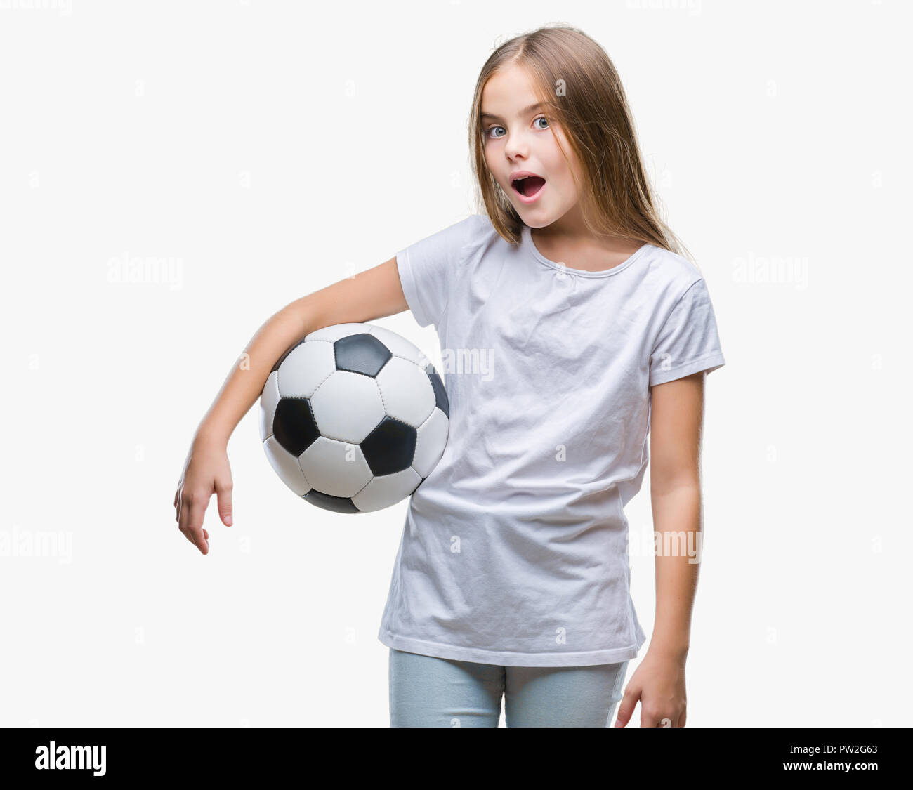 Young beautiful girl holding soccer football ball over isolated ...