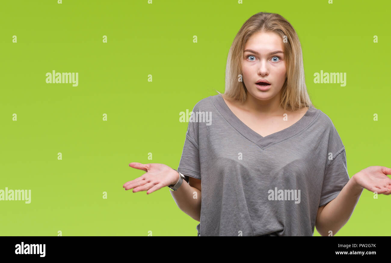 Young caucasian woman over isolated background afraid and shocked with ...