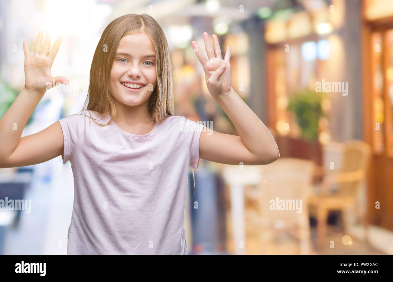 Young beautiful girl over isolated background showing and pointing up ...