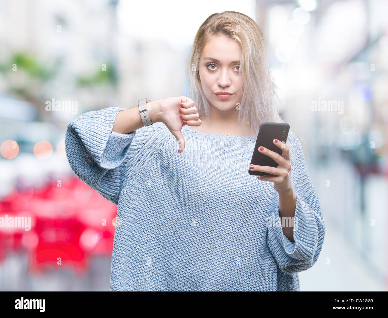 Young blonde woman texting sending message using smartphone over ...