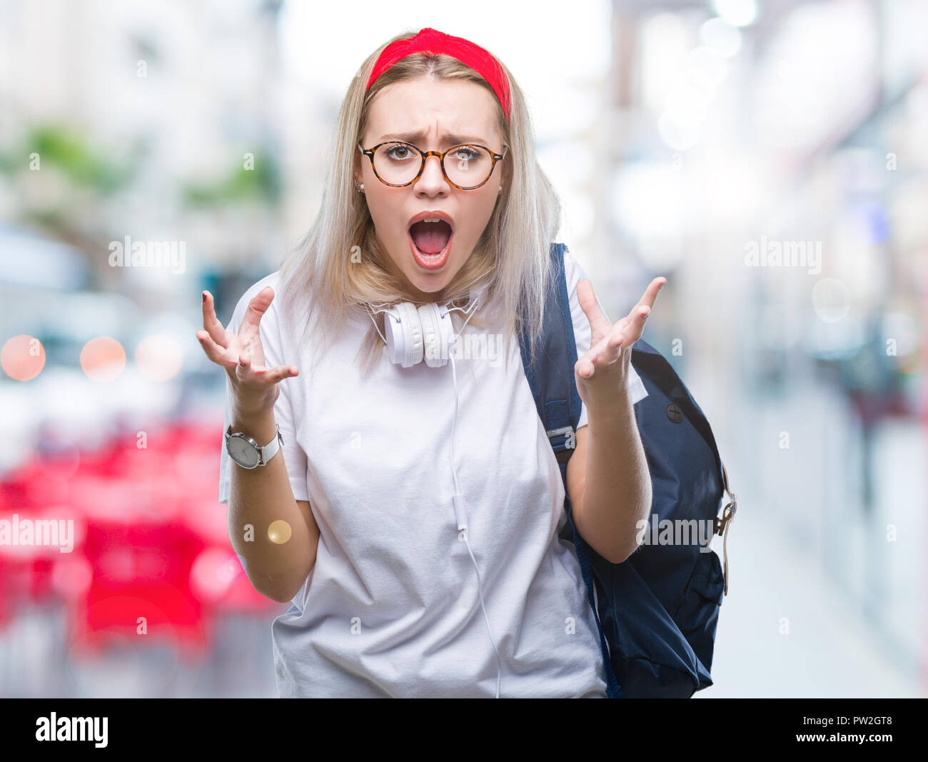 Young blonde student woman wearing glasses and backpack over isolated ...