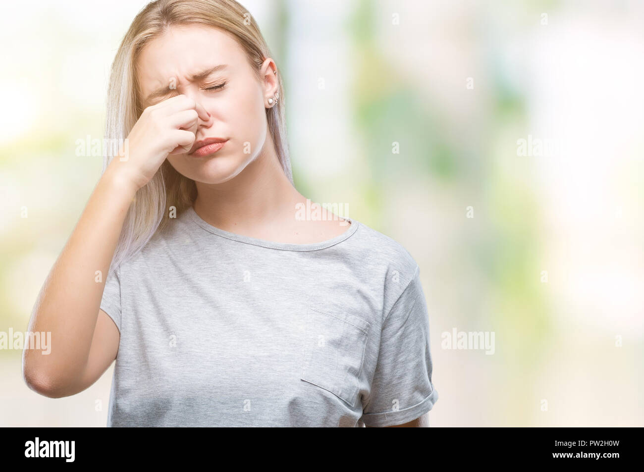 Young Blonde Woman Over Isolated Background Smelling Something Stinky