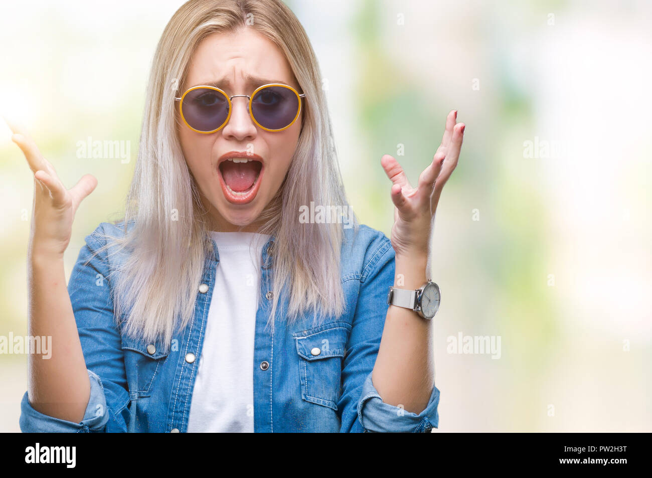 Young blonde woman wearing sunglasses over isolated background ...