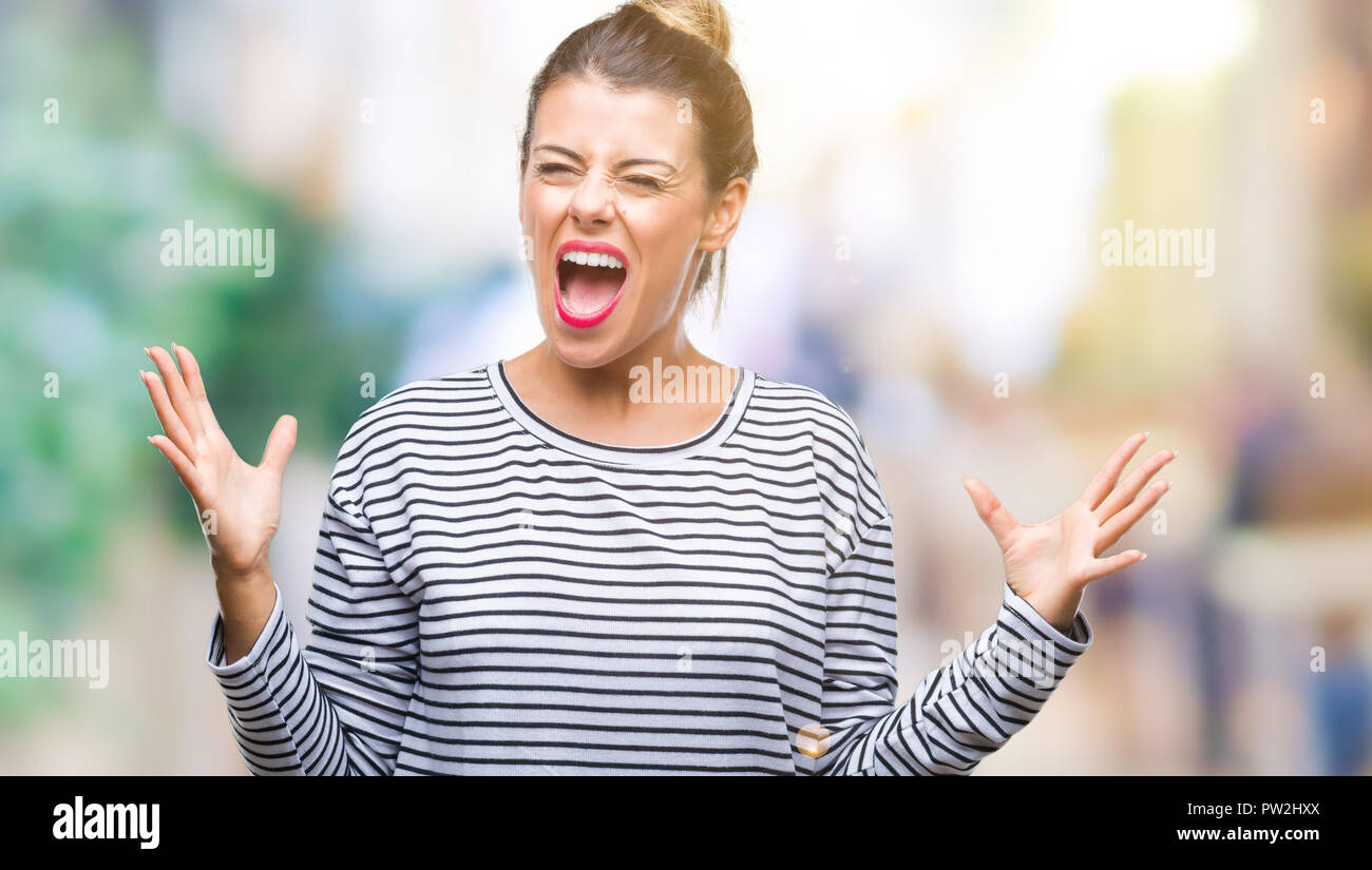 Young beautiful woman casual stripes sweater over isolated background ...