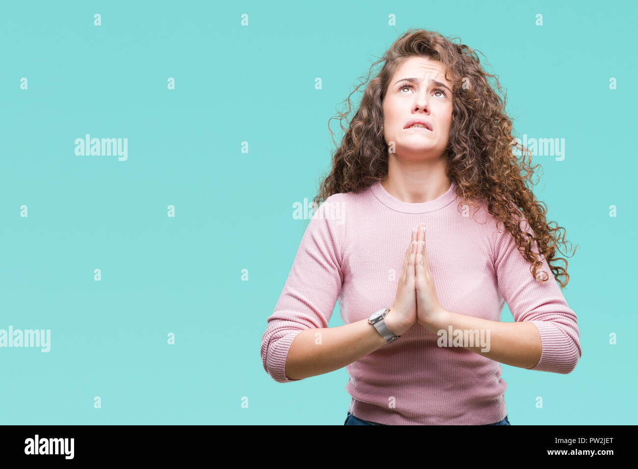 Beautiful brunette curly hair young girl wearing pink sweater over ...