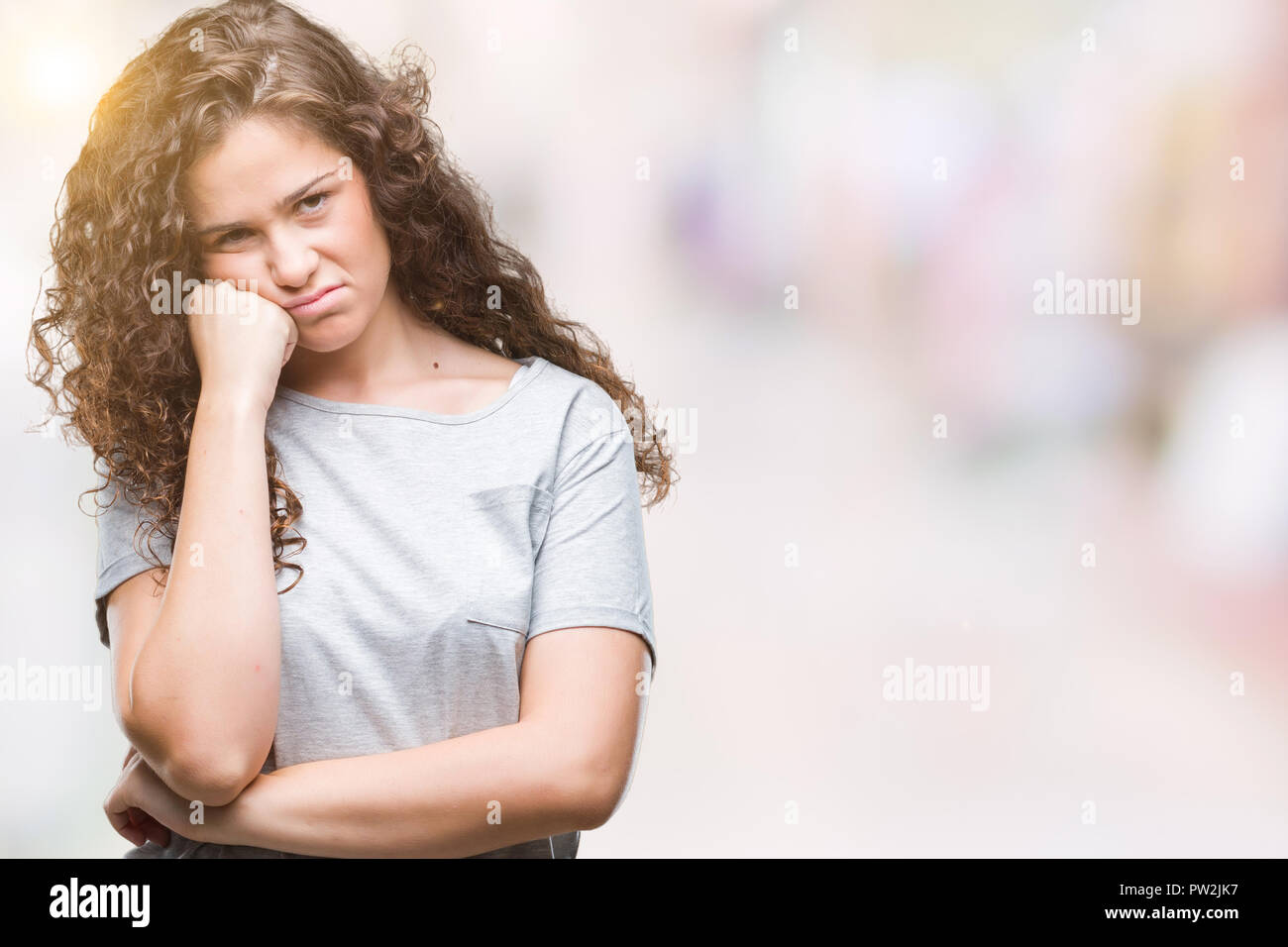 Beautiful young brunette curly hair girl wearing casual look over ...