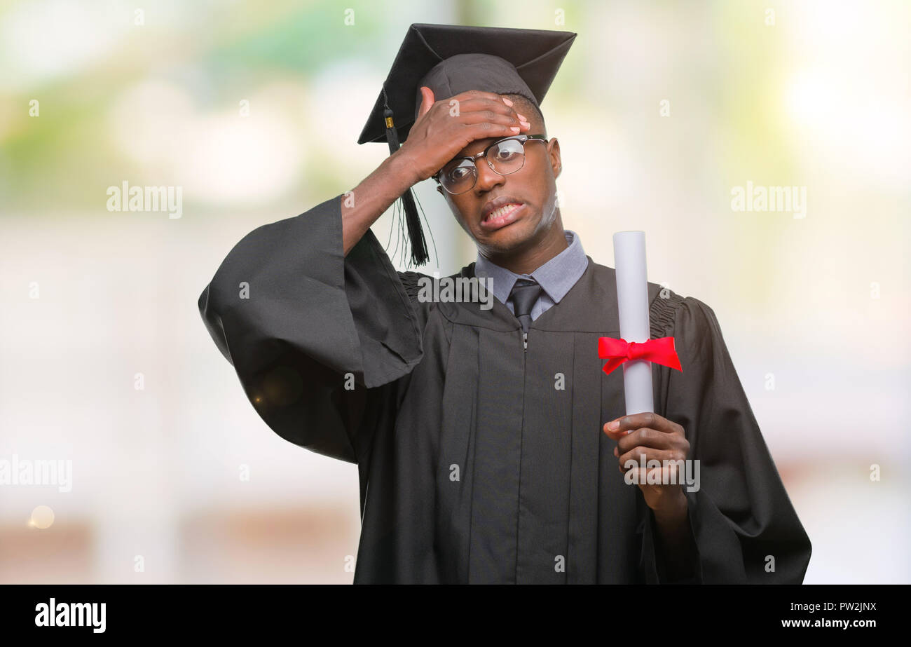 Young graduated african american man holding degree over isolated ...