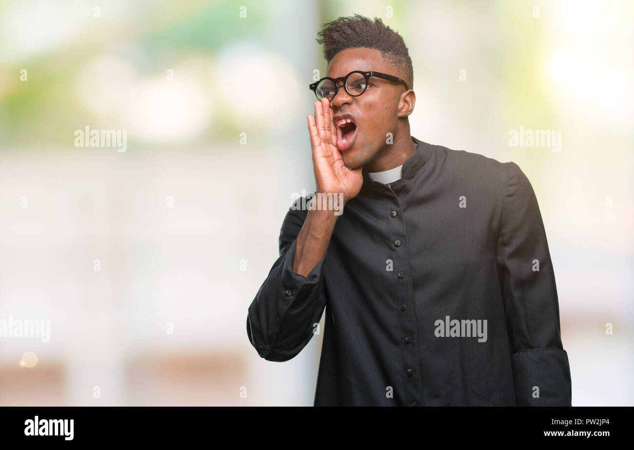 Young african american priest man over isolated background shouting and ...