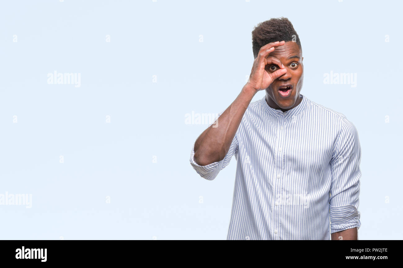 Young african american man over isolated background doing ok gesture ...