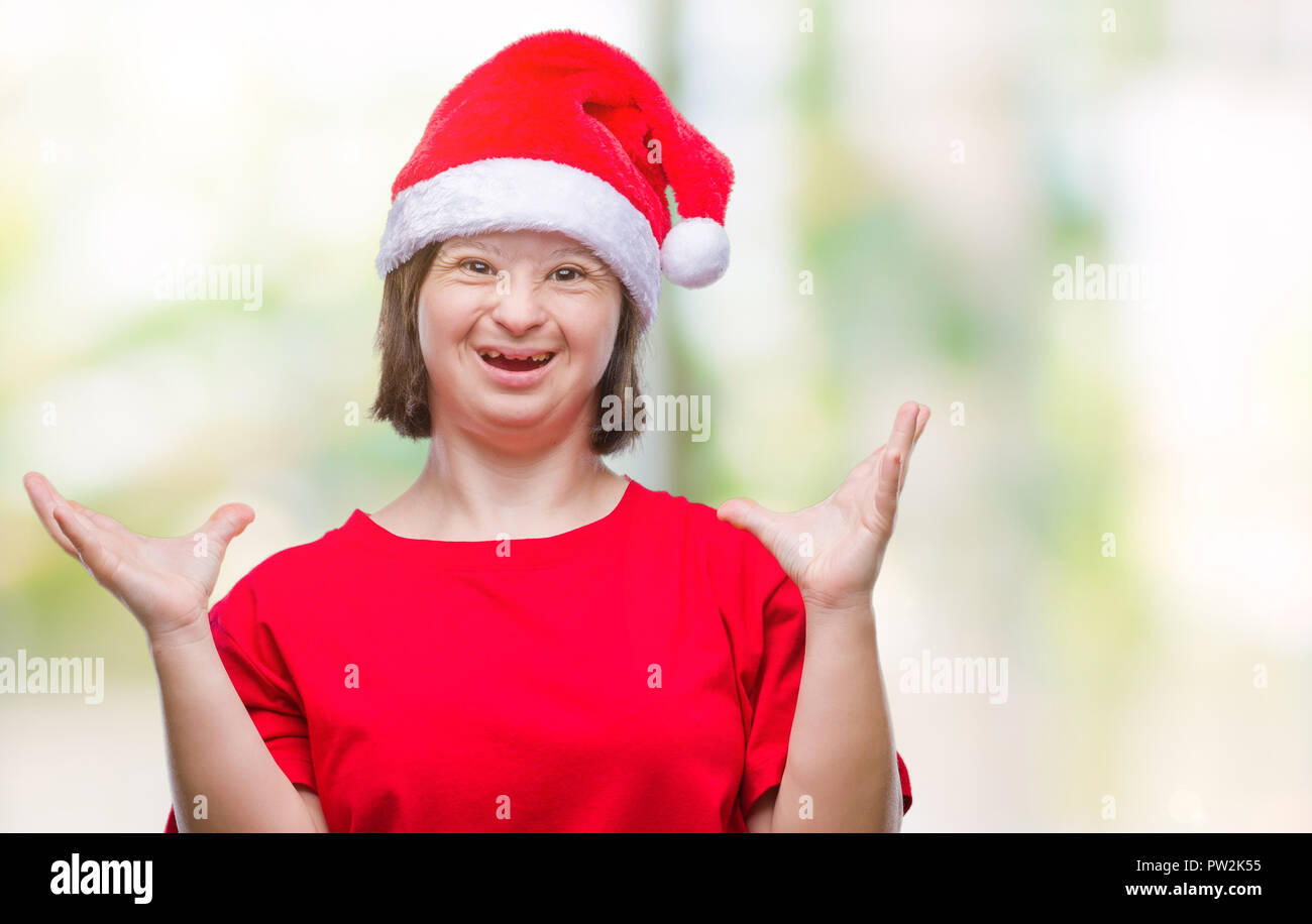 Young adult woman with down syndrome wearing christmas hat over ...