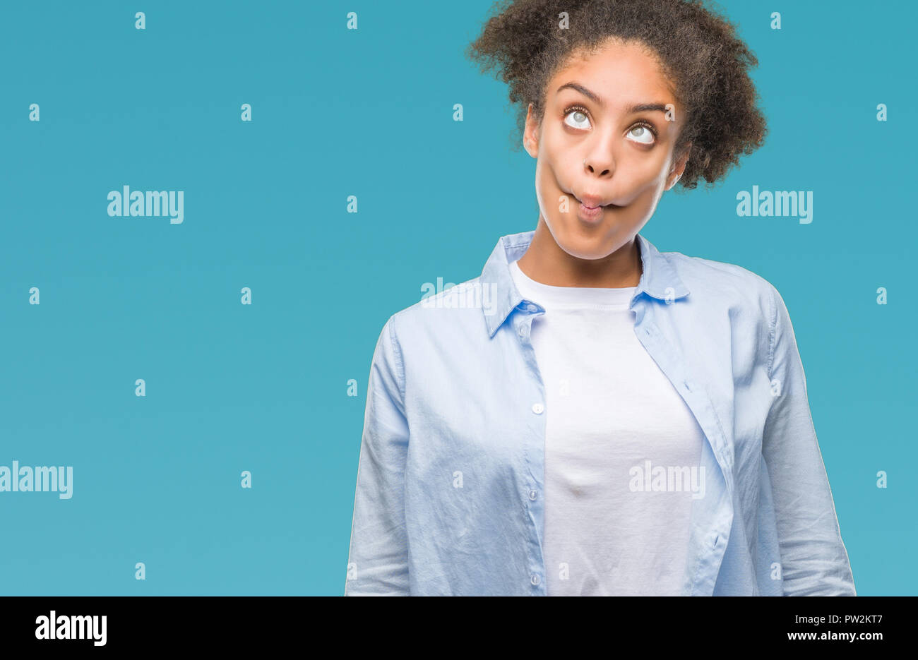 Young afro american woman over isolated background making fish face ...