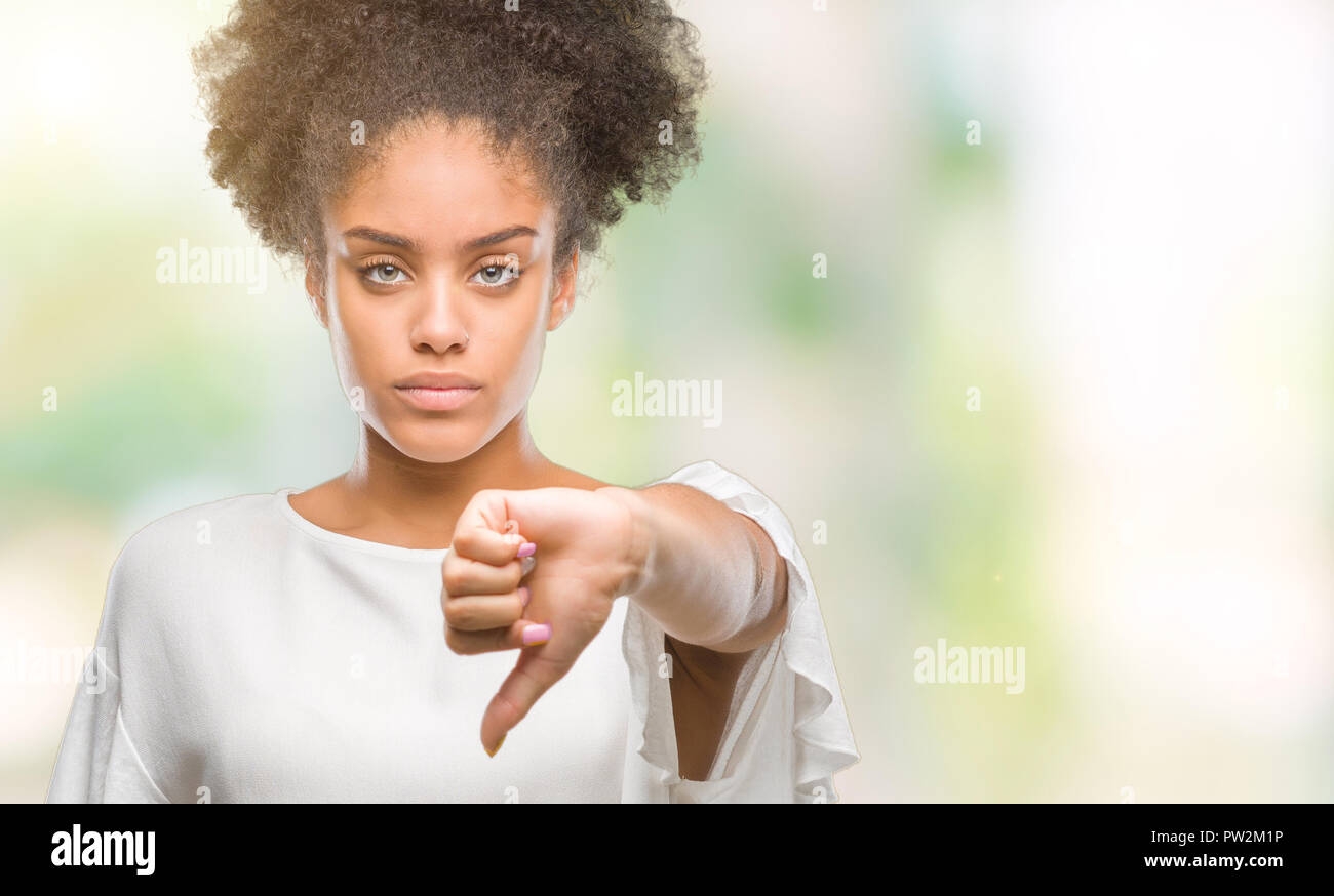 Young afro american woman over isolated background looking unhappy and ...