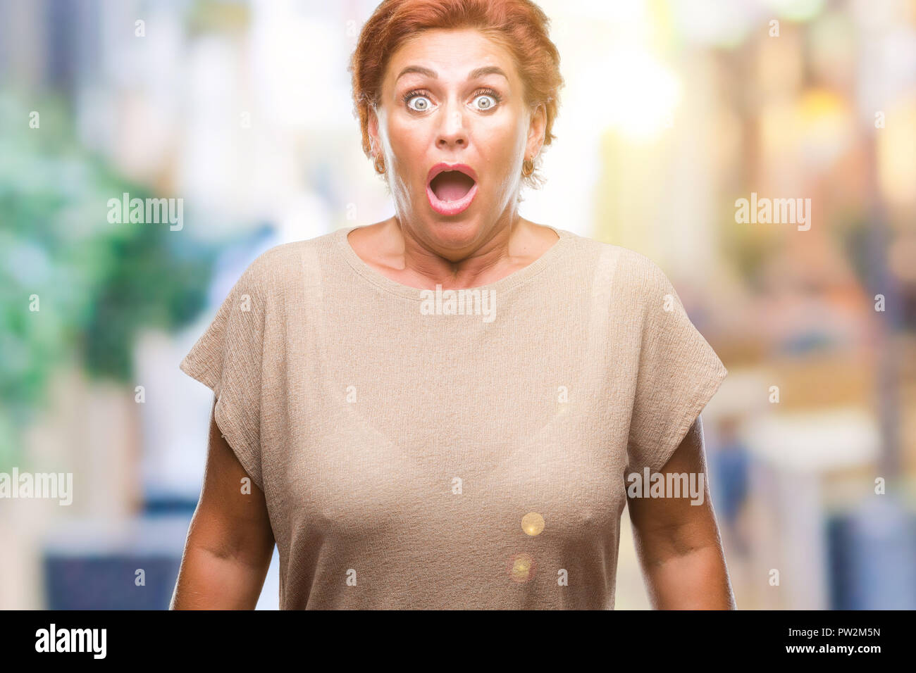 Atrractive senior caucasian redhead woman over isolated background ...