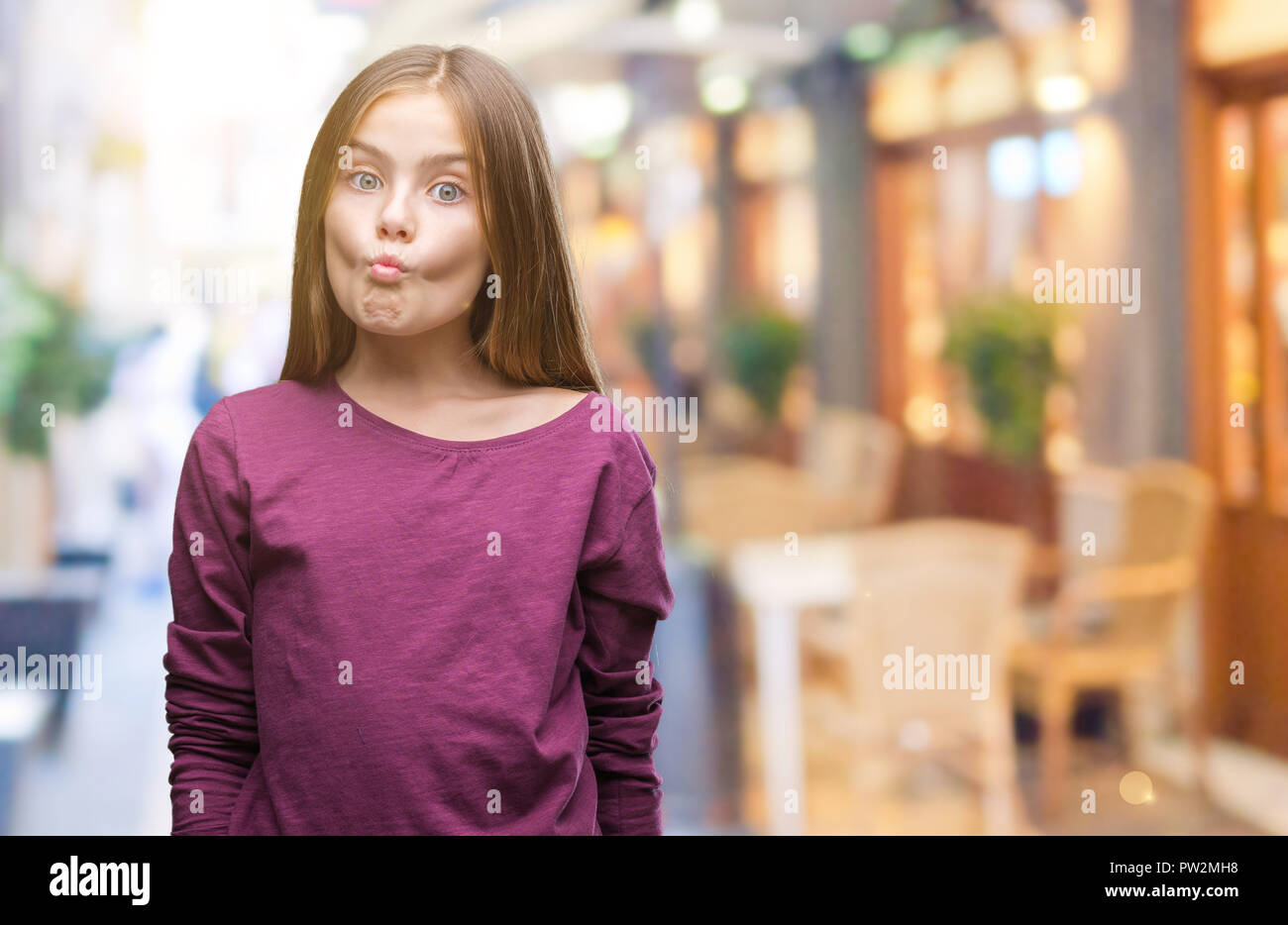 Young beautiful girl over isolated background making fish face with ...