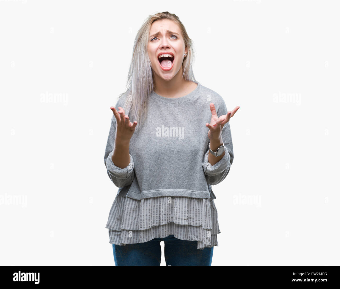 Young blonde woman over isolated background crazy and mad shouting and ...