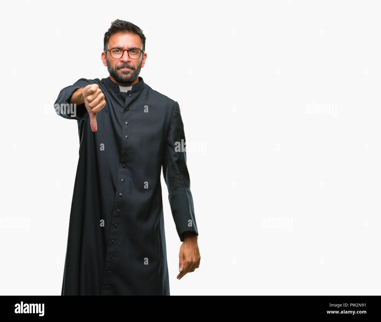 Adult hispanic catholic priest man over isolated background looking ...