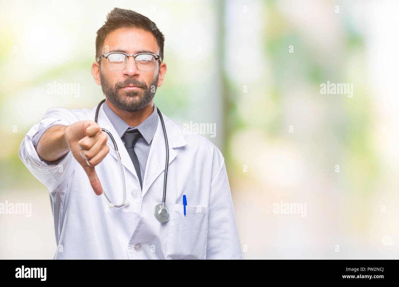 Adult hispanic doctor man over isolated background looking unhappy and ...