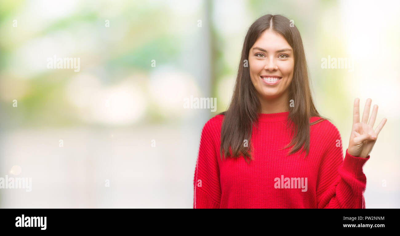 Young beautiful hispanic wearing red sweater showing and pointing up ...