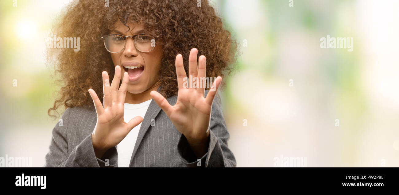 African american business woman wearing glasses afraid and terrified ...
