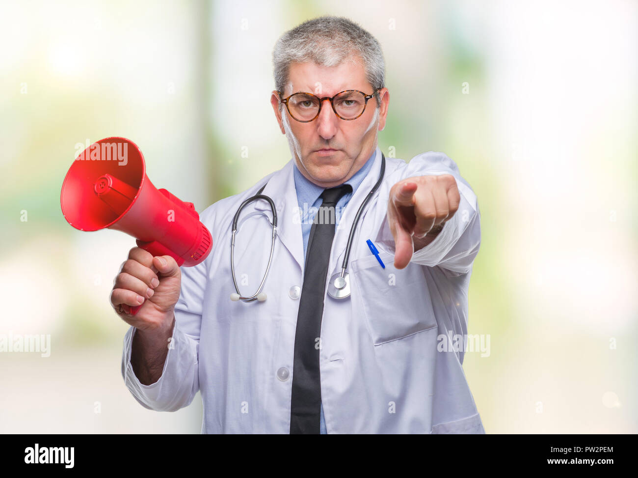 Handsome senior doctor man yelling through megaphone over isolated ...