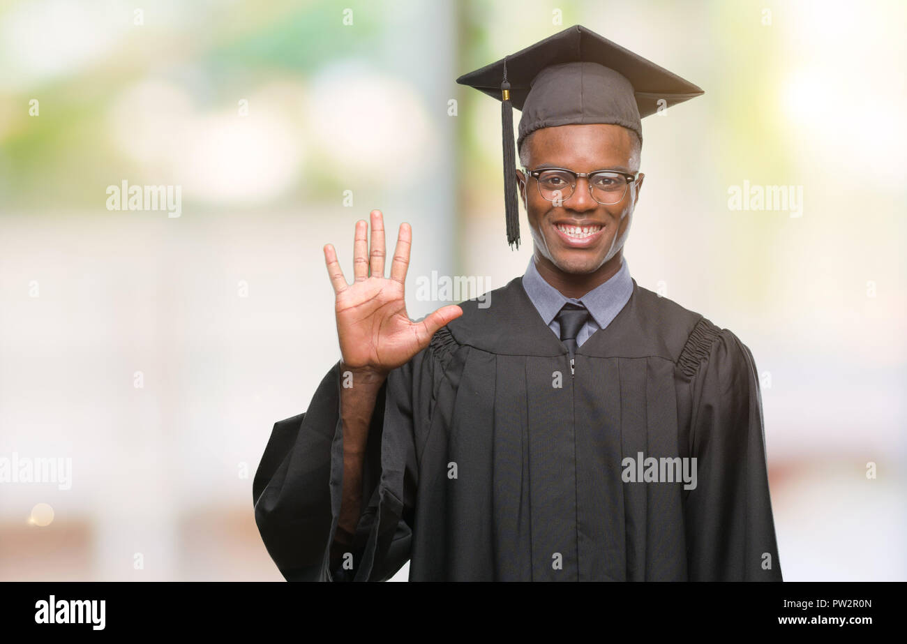 Young graduated african american man over isolated background showing ...