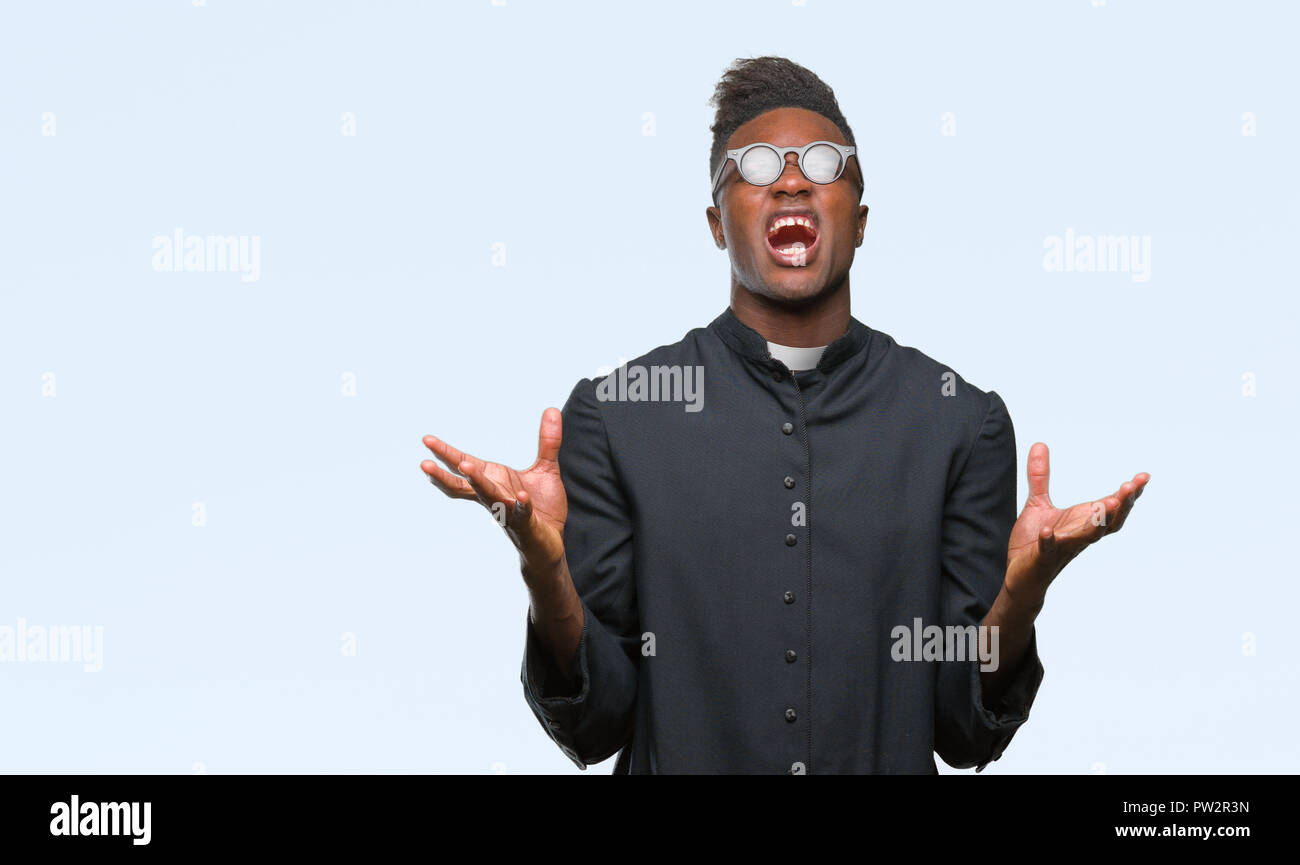 Young african american priest man over isolated background crazy and ...