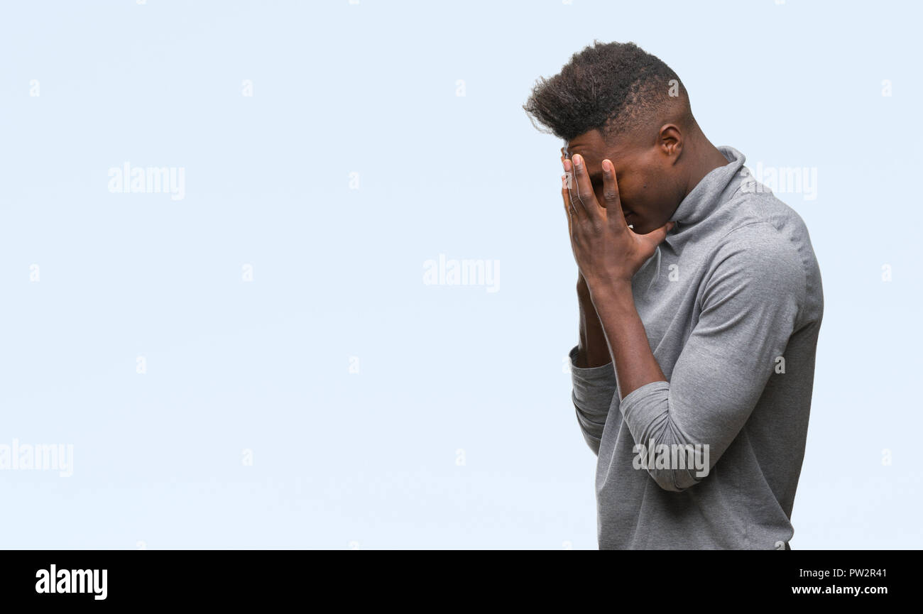 Young african american man over isolated background with sad expression ...