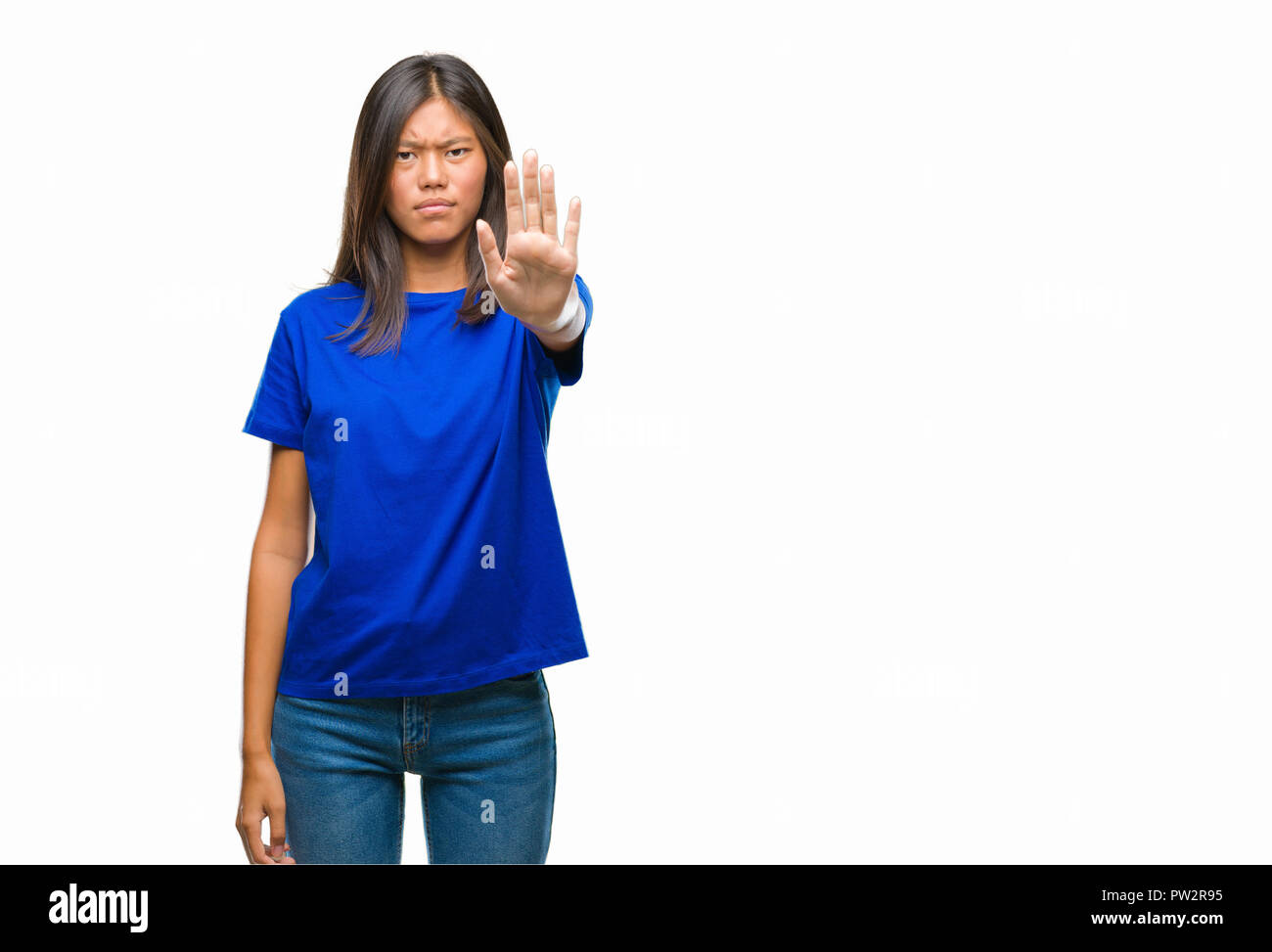 Young asian woman over isolated background doing stop sing with palm of ...
