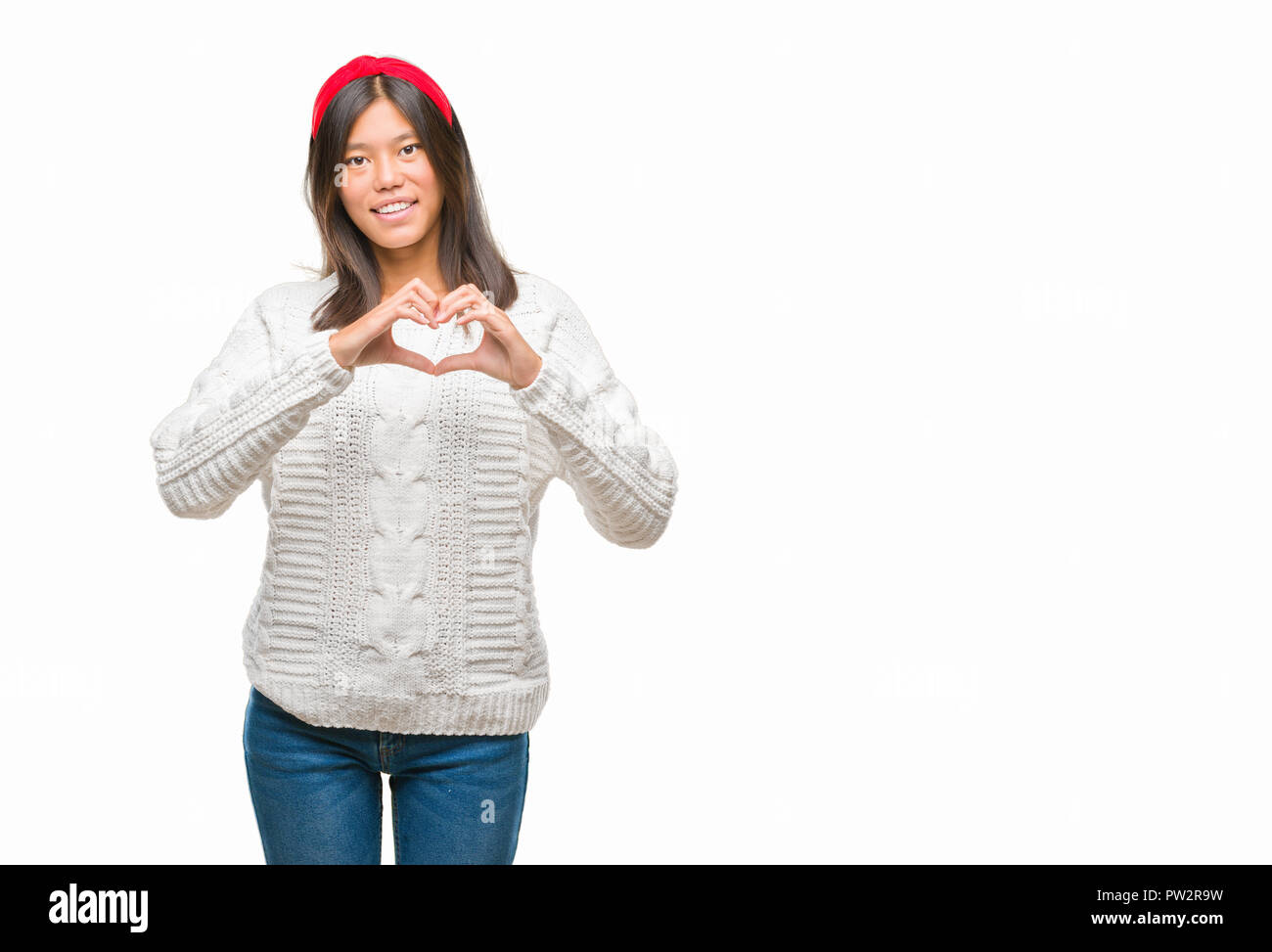 Young asian woman wearing winter sweater over isolated background ...