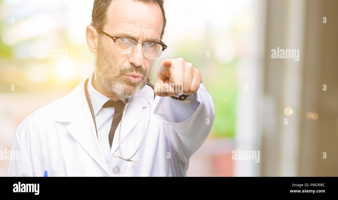Doctor senior man, medical professional pointing to the front with ...