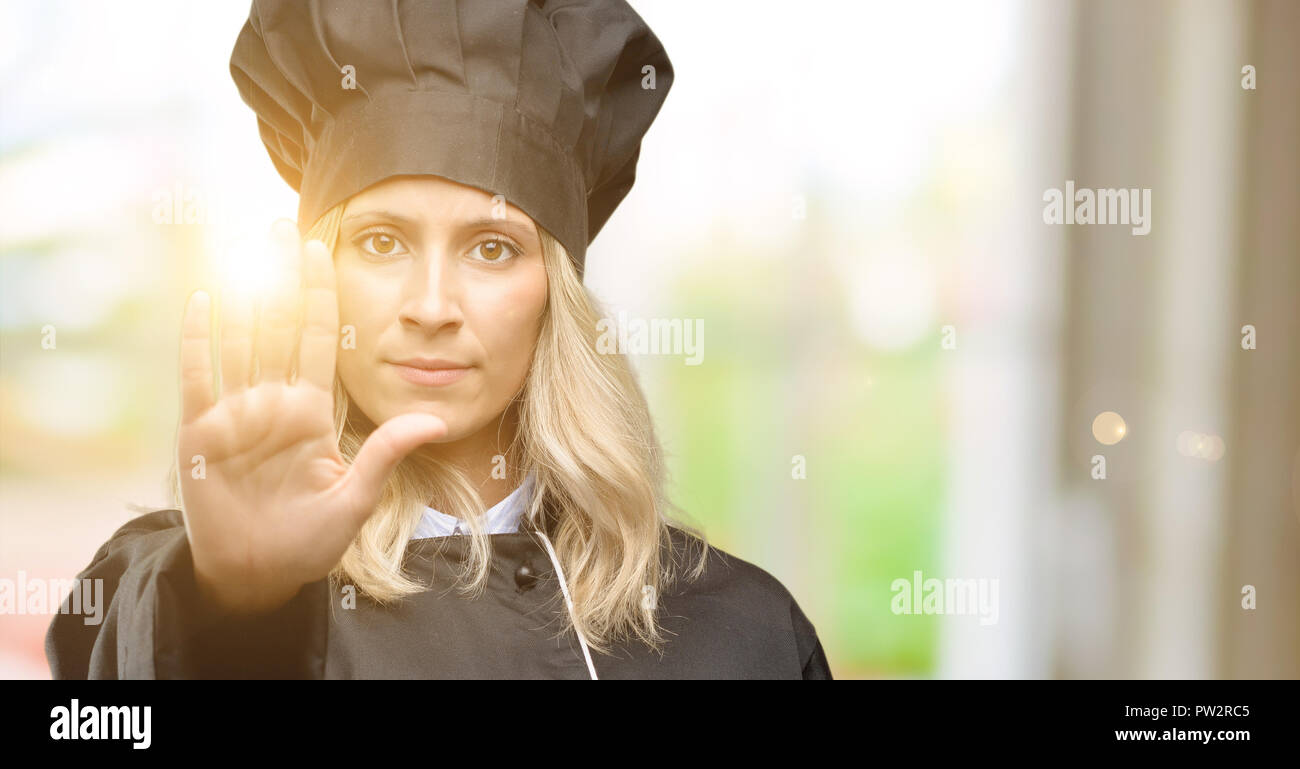 Beautiful cook woman chef annoyed with bad attitude making stop sign ...