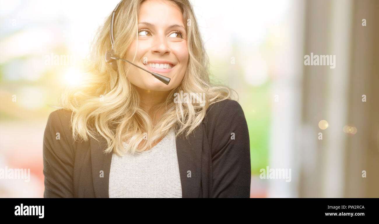 Young woman operator from call center thinking and looking up ...