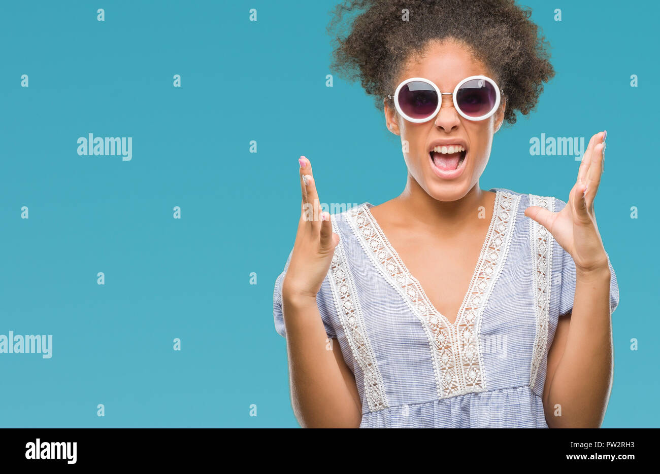 Young afro american woman wearing glasses over isolated background ...
