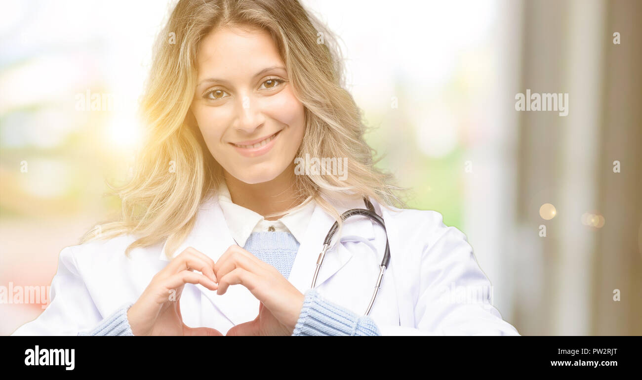 Young doctor woman, medical professional happy showing love with hands ...