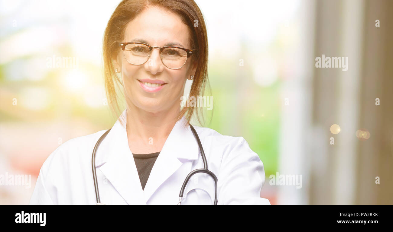 Doctor woman, medical professional holds hands welcoming in handshake ...