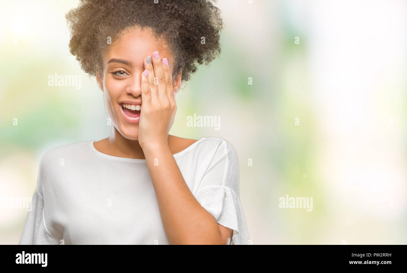 Young afro american woman over isolated background covering one eye ...