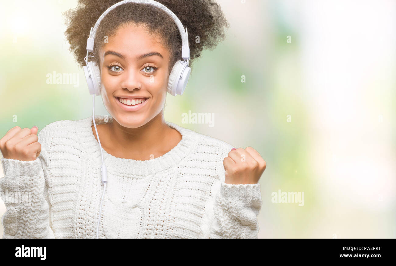 Young afro american woman wearing headphones over isolated background ...
