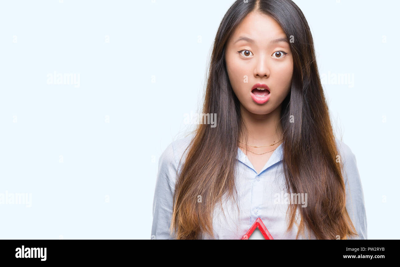Young asian woman real state agent holding house isolated background ...