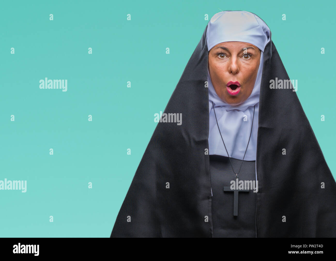 Middle age senior christian catholic nun woman over isolated background ...