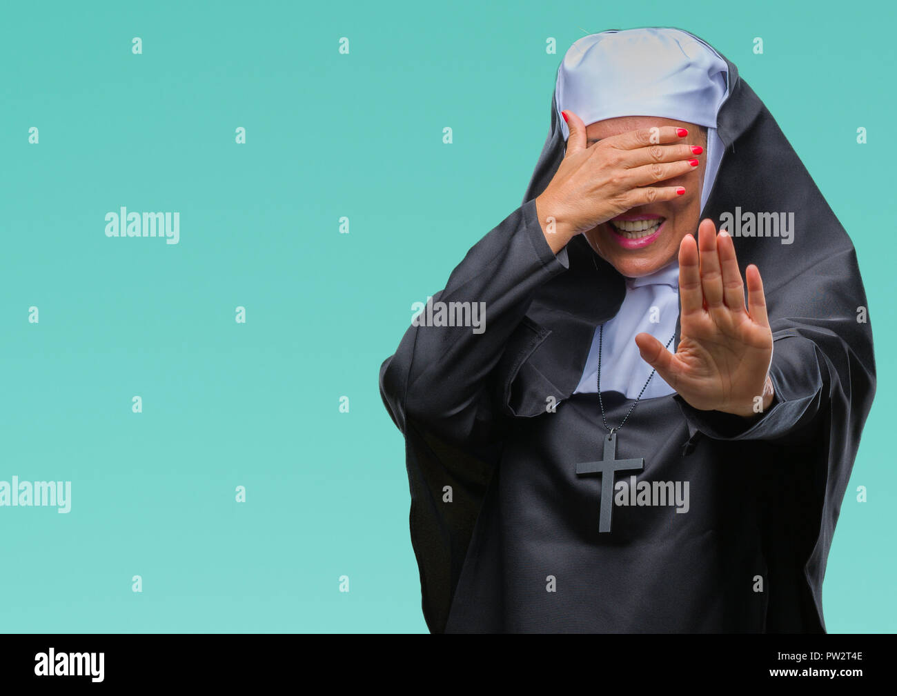 Middle age senior christian catholic nun woman over isolated background ...