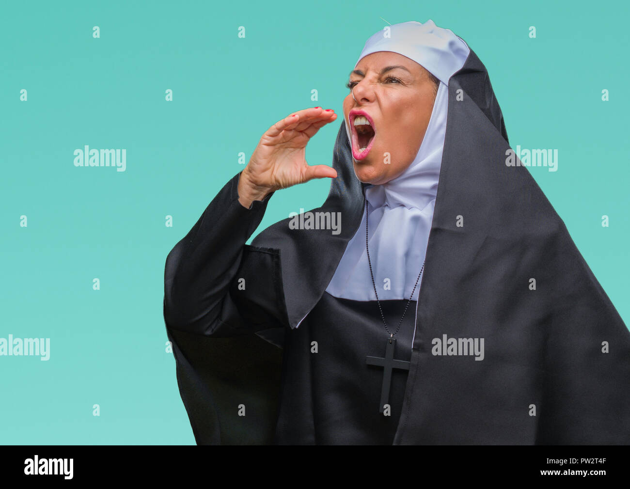 Middle age senior christian catholic nun woman over isolated background ...
